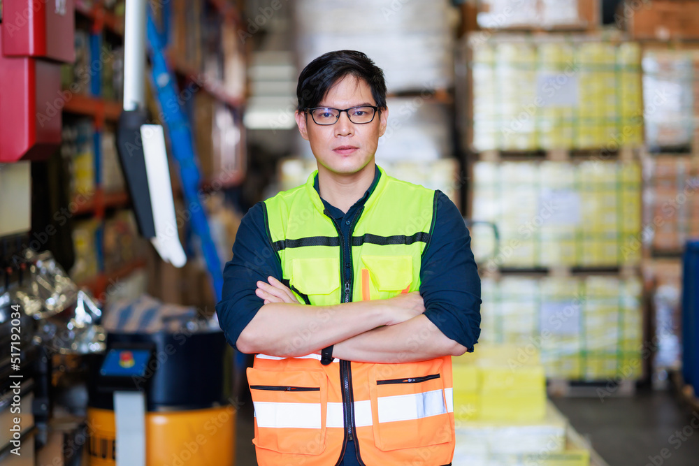 Portrait handsome Asian male warehouse professional worker in safety ...
