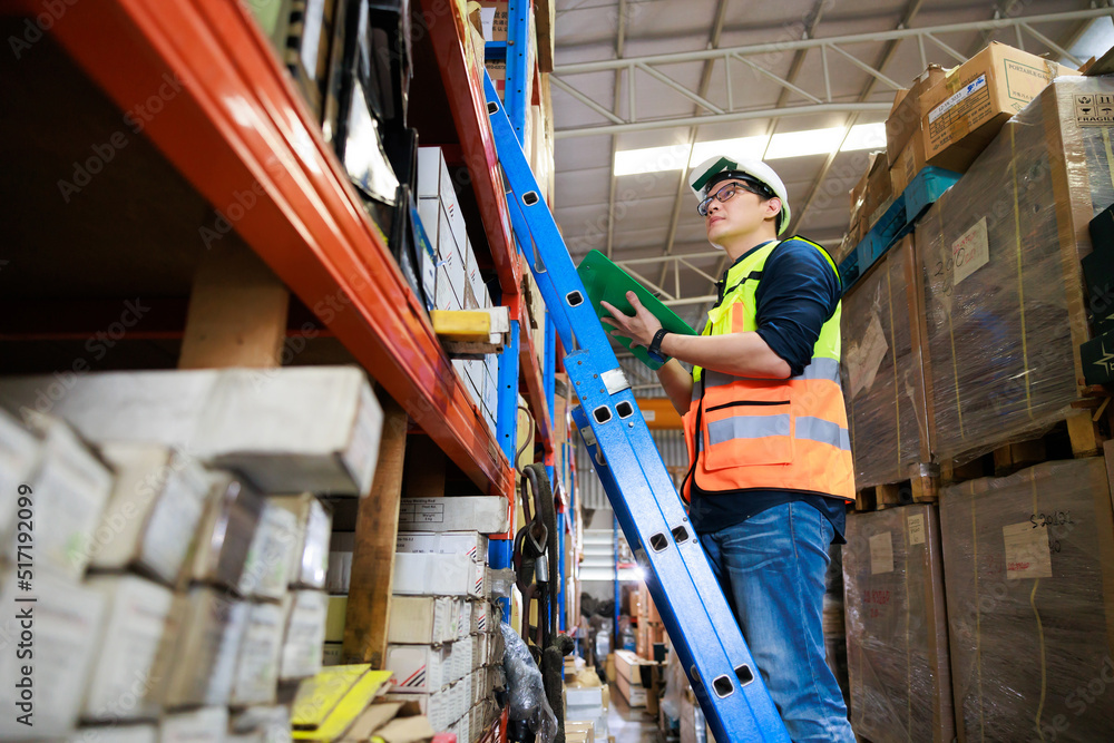 Portrait handsome Asian male warehouse professional worker in safety ...