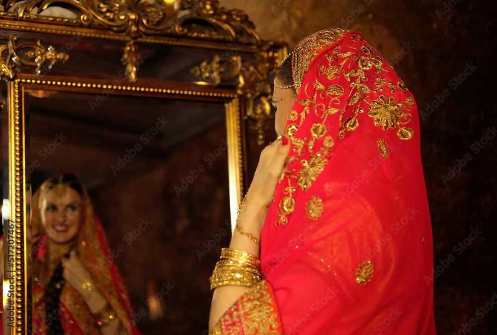 woman in a red sari, traditional Indian wedding dress, the bride looks ...