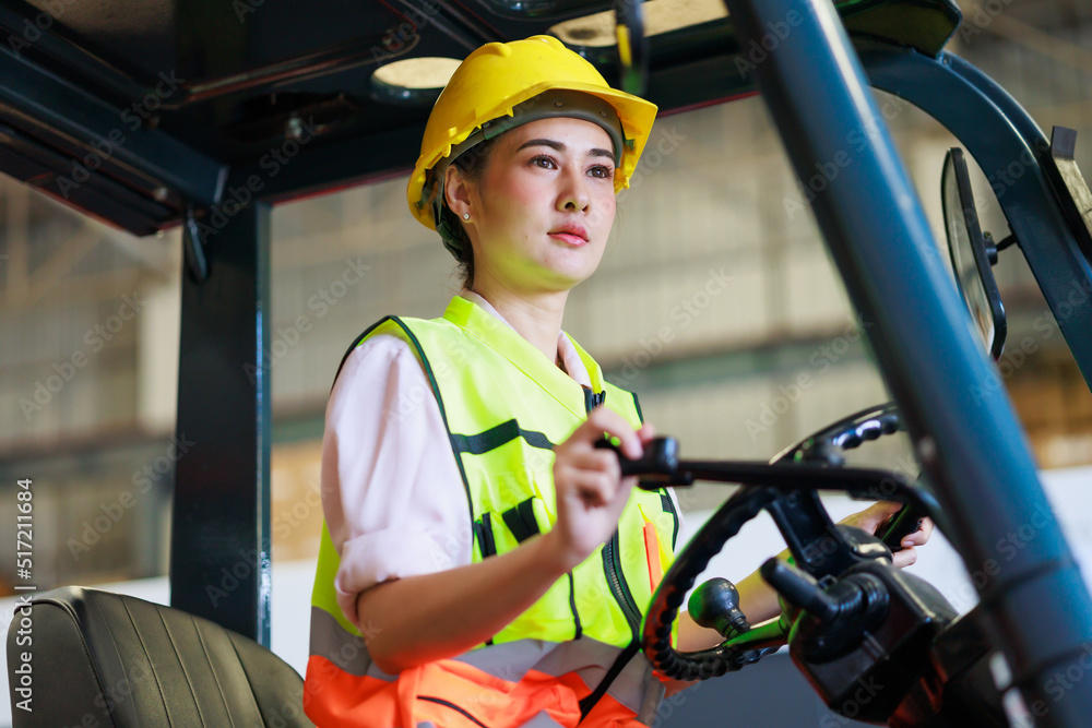 Young asian woman Warehouse staff driving forklift operator moving ...