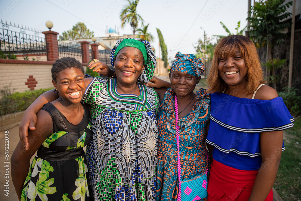 multigenerational group of female african friends together hugging and ...