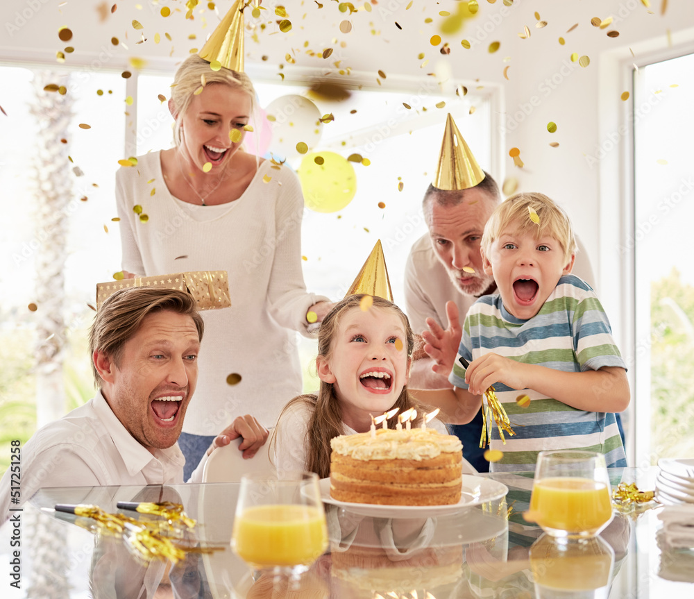 Cheerful generational happy family wearing party hats while celebrating ...