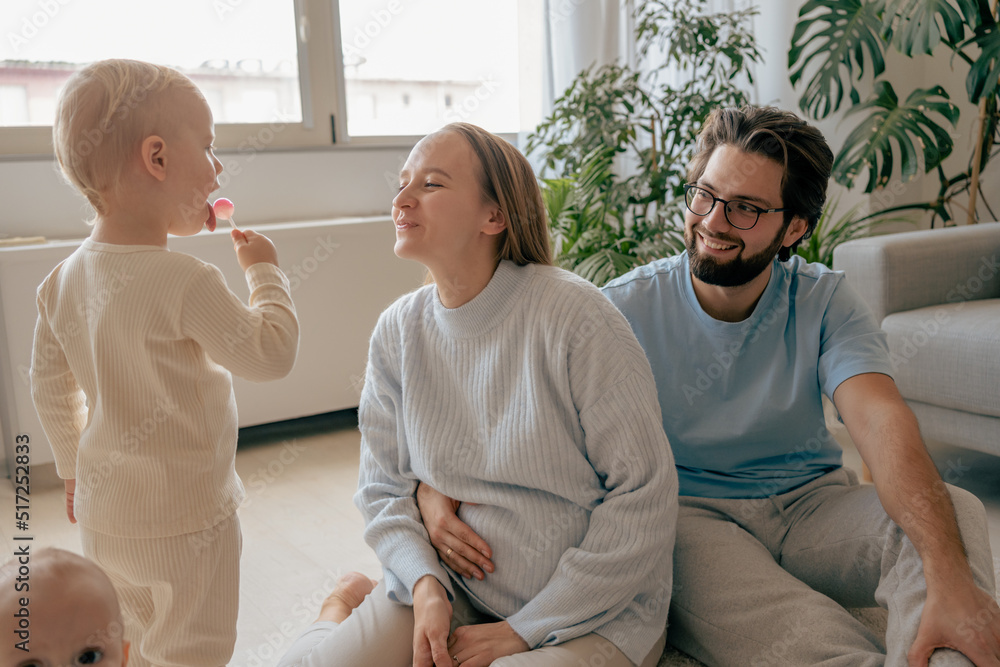 Mother is expecting a baby. Child playing with their pregnant mother at ...