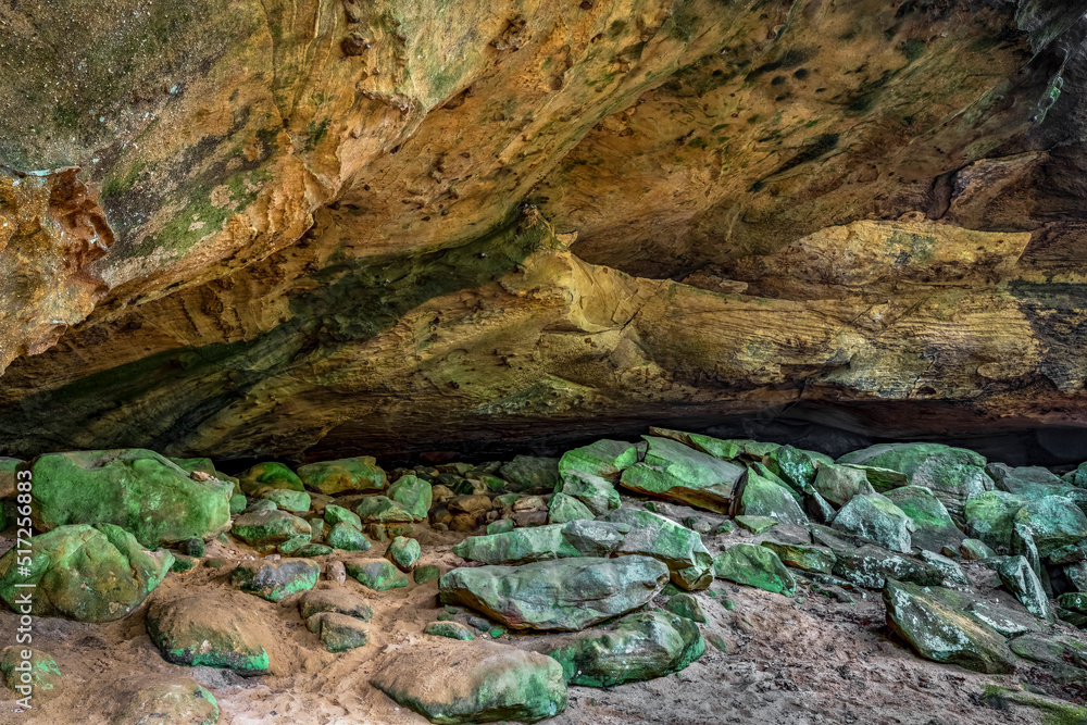 Colorful rock boulders litter the floor beneath the ceiling of one of ...