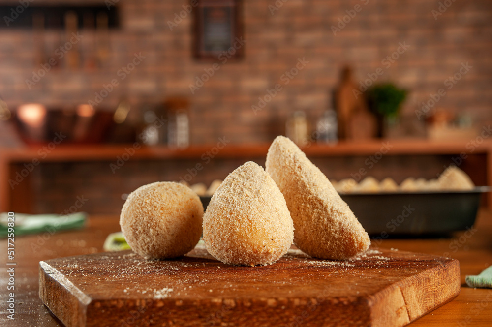 Breading brazilian croquettes (coxinha de frango, risolis de carne e ...
