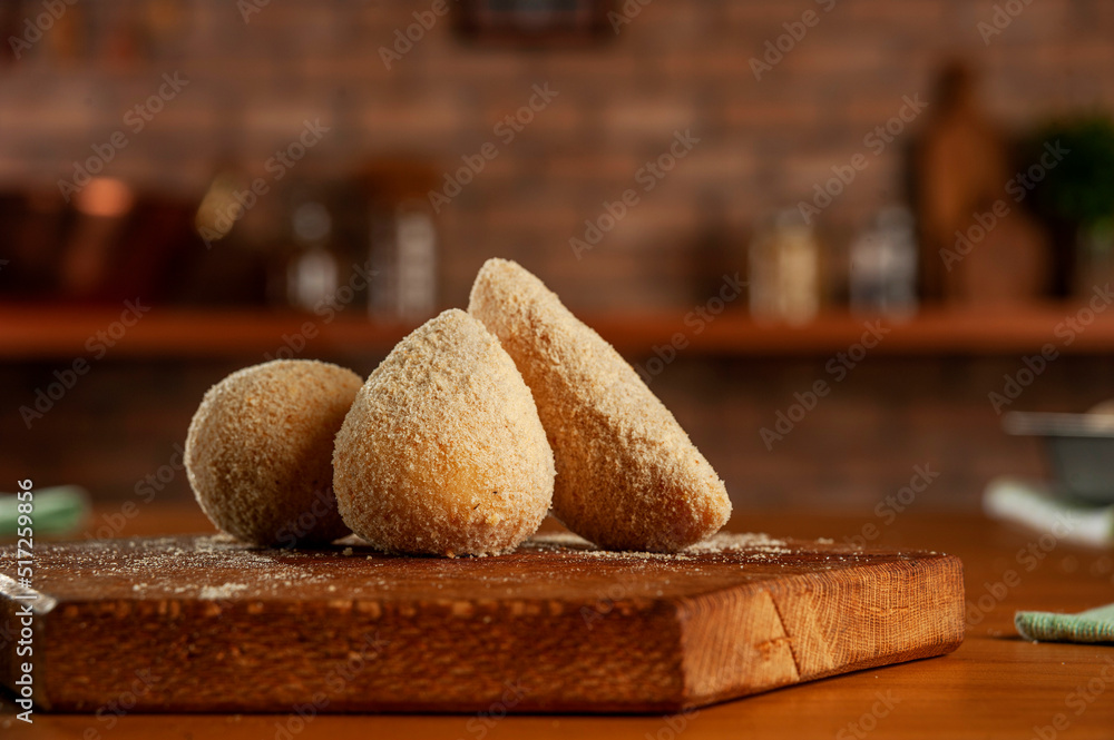 Breading brazilian croquettes (coxinha de frango, risolis de carne e ...