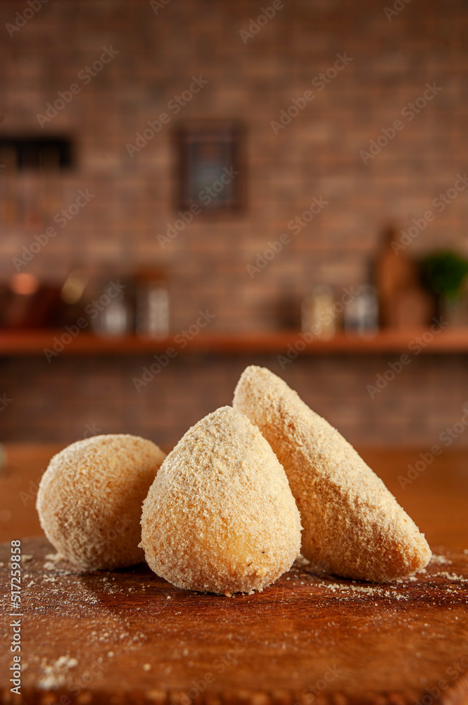 Breading brazilian croquettes (coxinha de frango, risolis de carne e ...