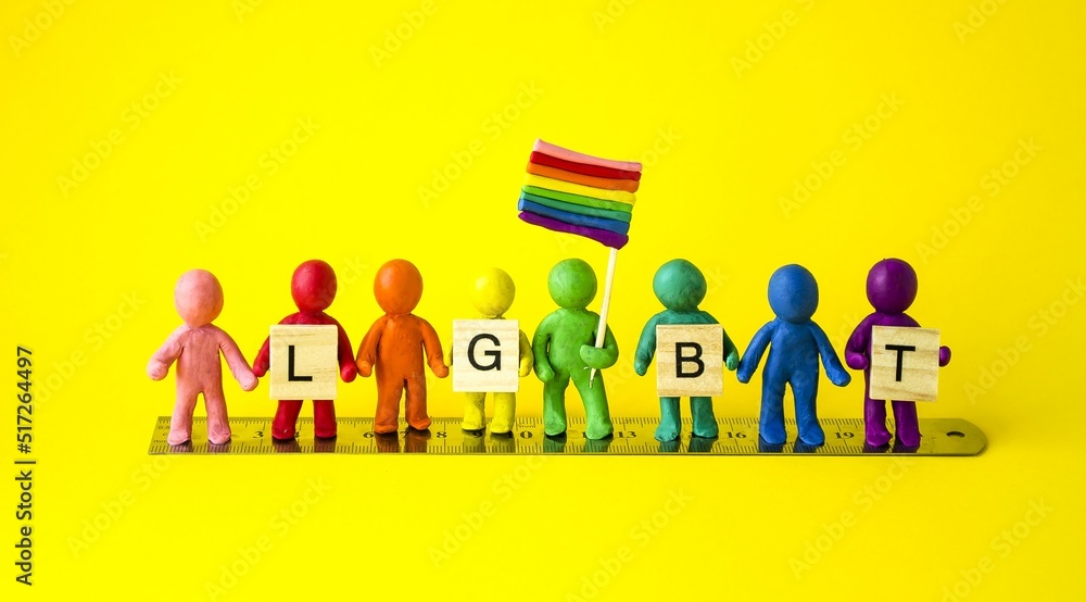 On a yellow background, multi-colored people from plasticine stand in a ...