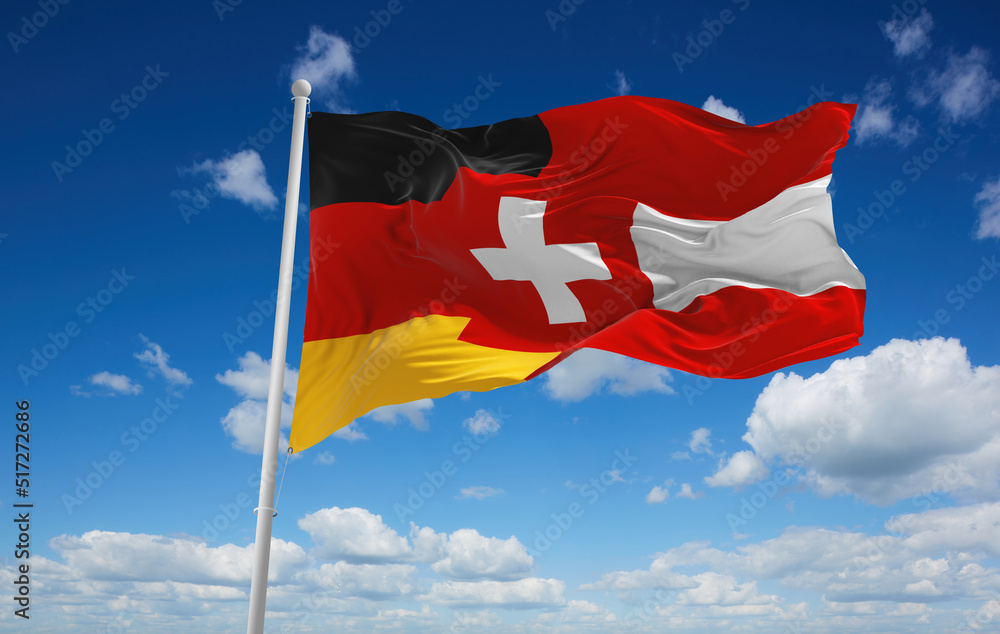 official flag of Austria, Germany, Switzerland Austria at cloudy sky ...