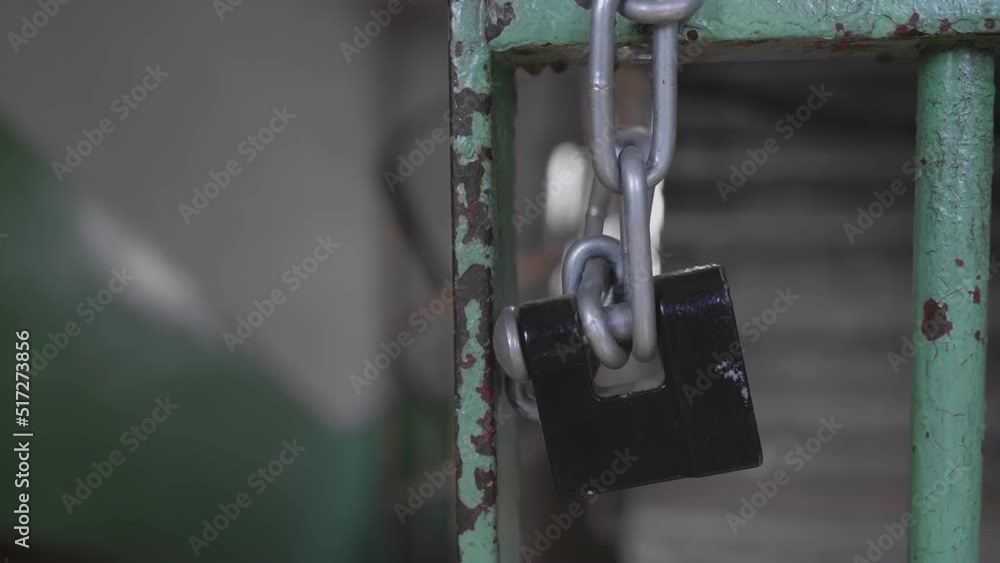 Close-up of lock on chain hanging on latticed iron door against ...