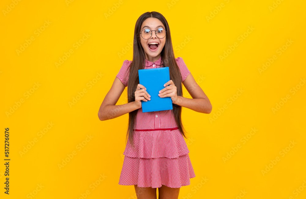Amazed teen girl. Schoolgirl with copy book posing on isolated ...