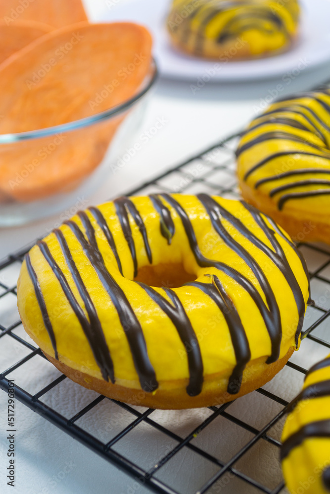 Donat ubi kuning or yellow sweet potato donuts. made from yellow sweet ...