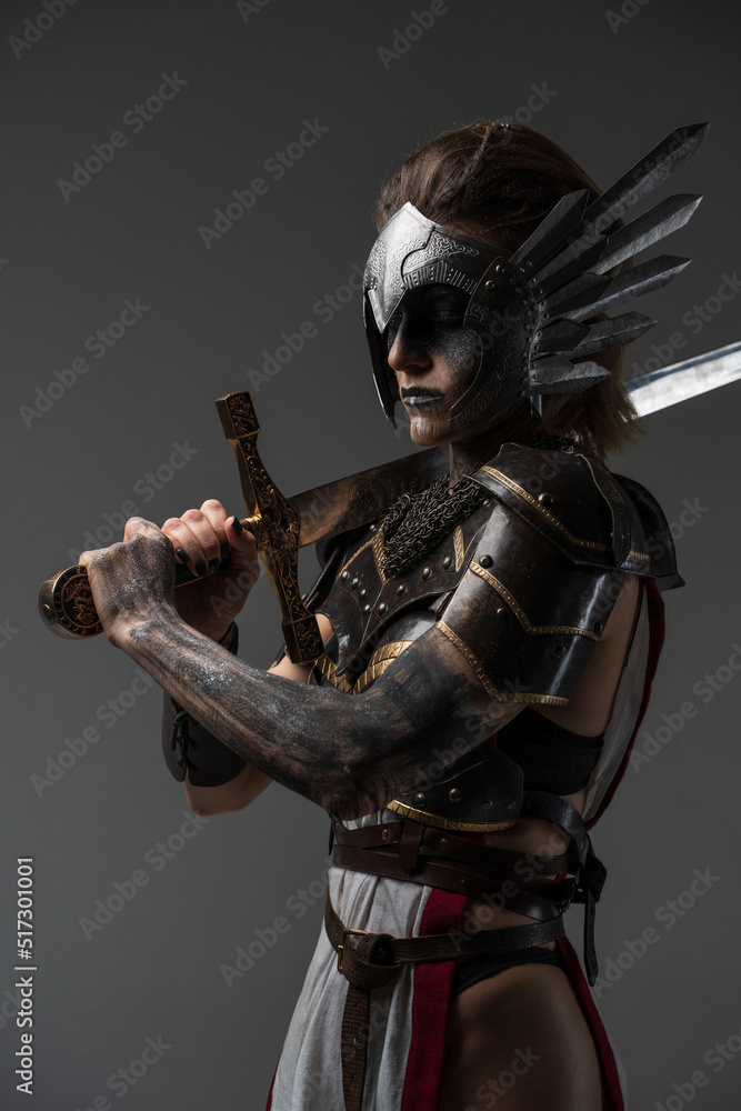 Attractive valkyrie from past with make up holding sword on her ...