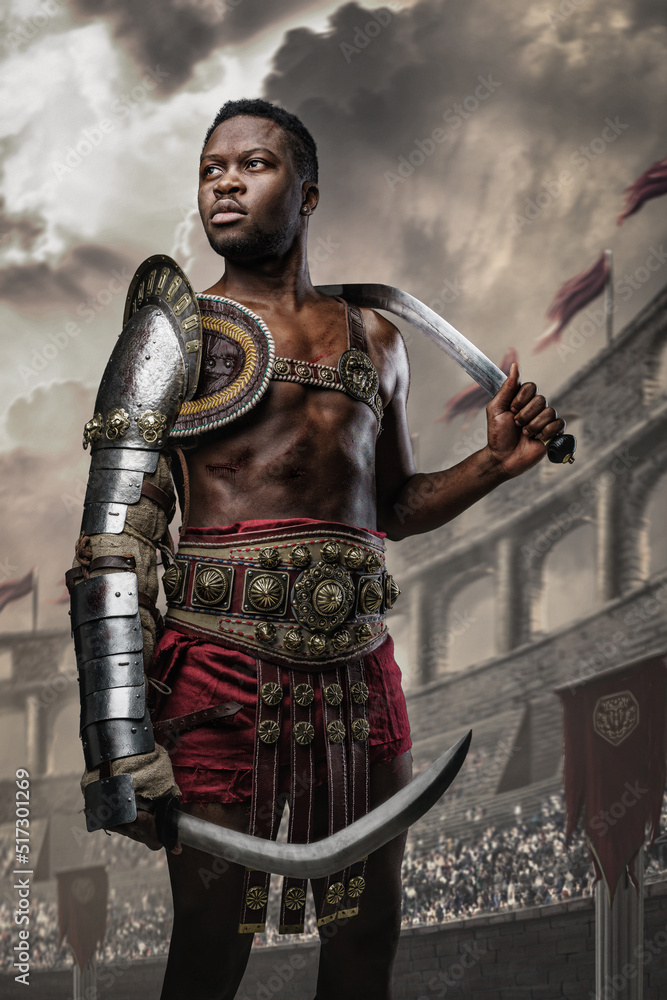 Portrait of handsome gladiator of african ethnic dressed in light armor ...