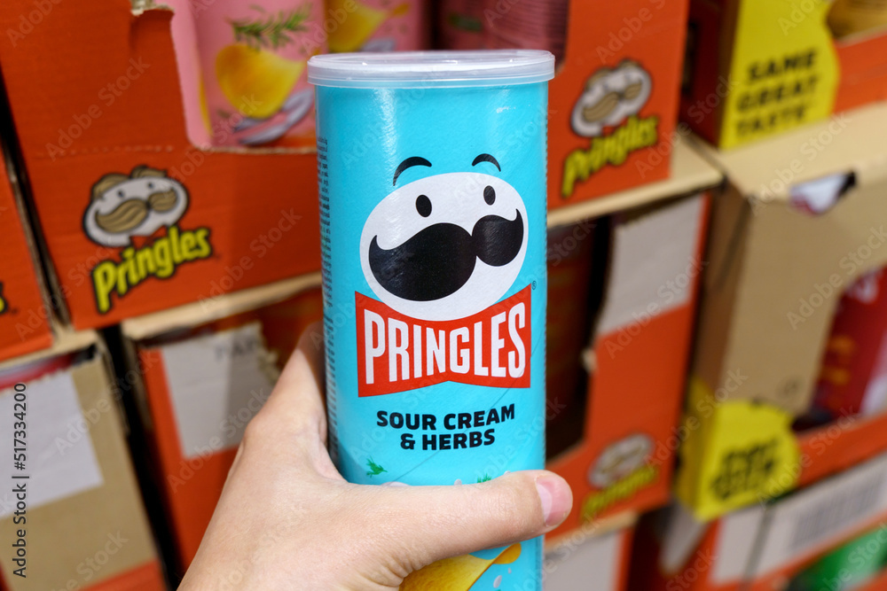 Tyumen, Russia-May 08, 2022: Hand hold a new tube of Pringles Potato ...