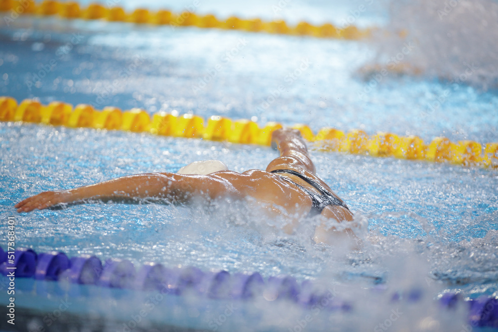 Details with a professional female athlete swimming in an olympic ...