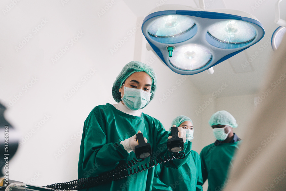 Medical team performing surgical operation and is using a heart pump to ...