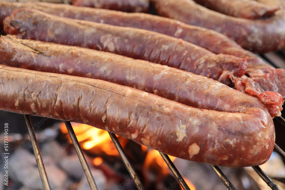 South African braai, Boerewors sausage on a braai grid. Barbecue. Wors ...