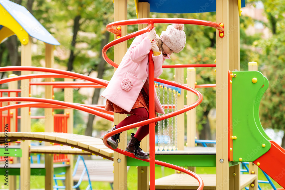 Pretty girl kid playing at playground at autumn day. Leisure of preteen ...