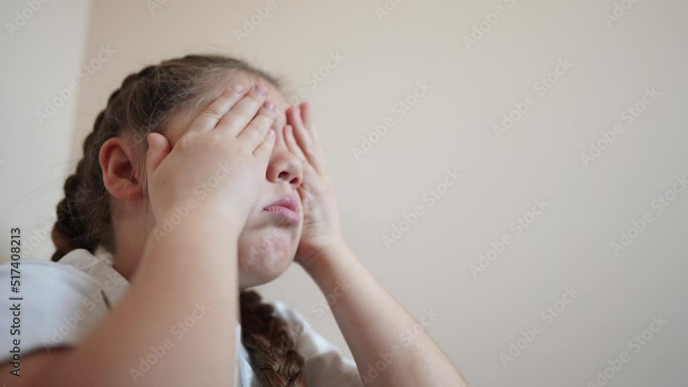 sad girl sitting in the corner crying a covered her face with her hands ...