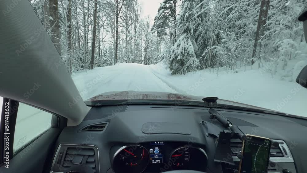 View from a car while driving in a snowy forest during the nordic ...