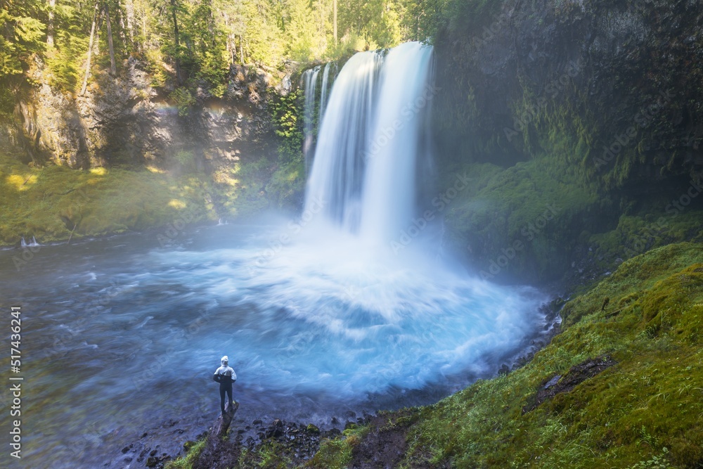 Man standing by a Koosah Falls, also known as Middle Falls, is second ...
