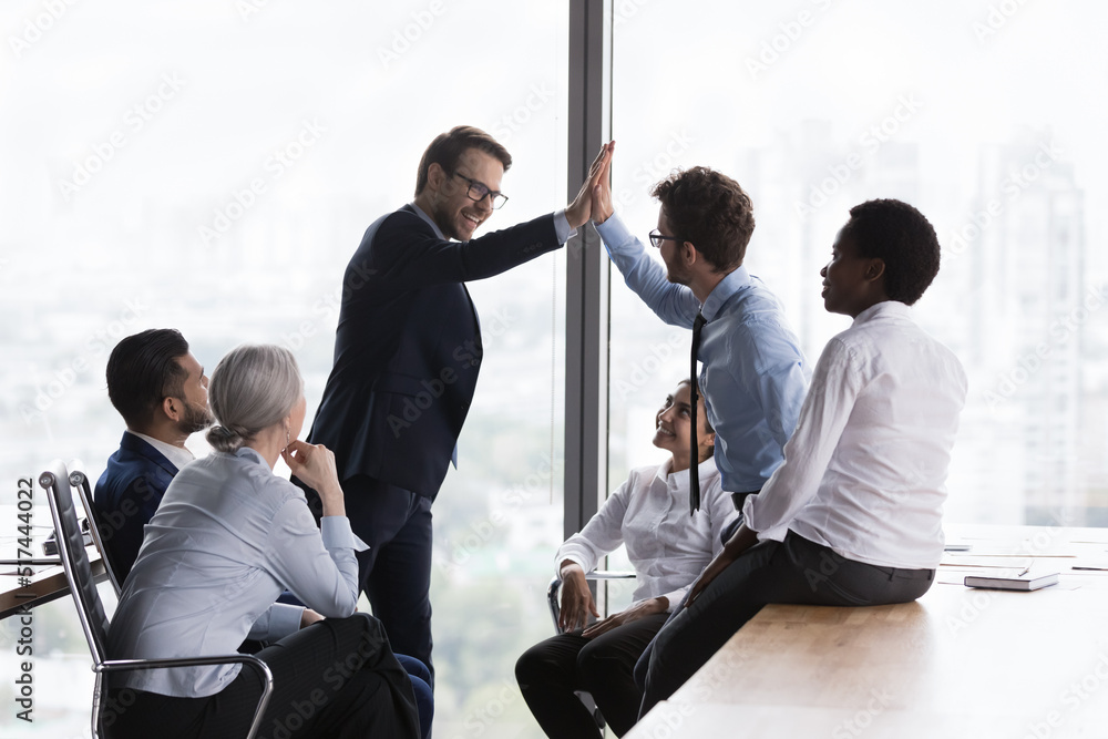 Happy coworkers clapping hands at team meeting, celebrating group ...