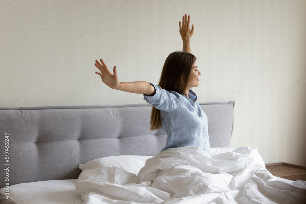 Young rested after healthy night sleep woman wake up do stretching ...