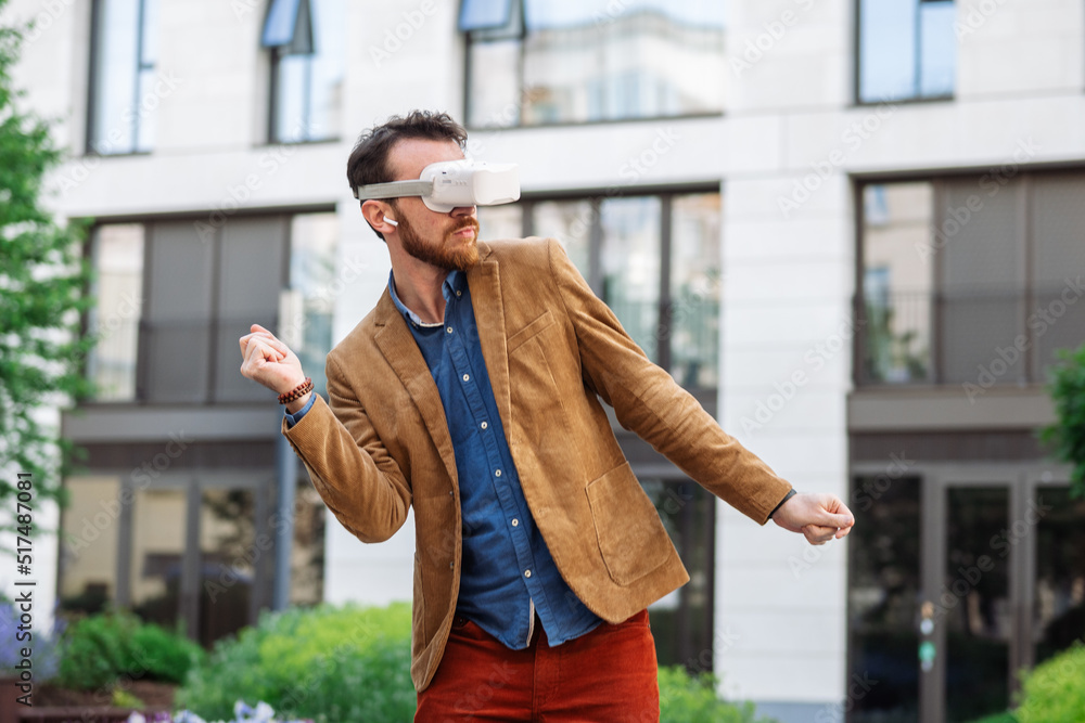 Portrait of man in virtual reality glasses. Guy in VR headset watching ...