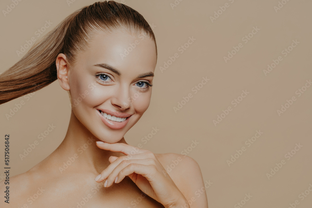 Tranquil undressed woman with healthy perfect skin, dark hair combed in ...