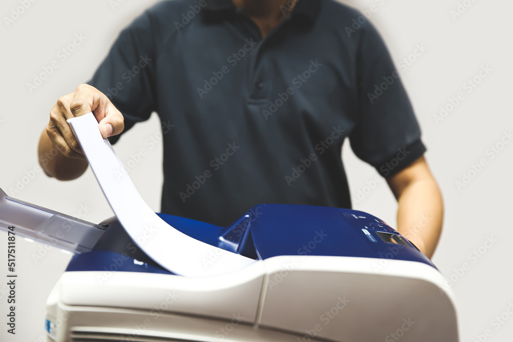 Technician hand press button and load paper in tray to using ...