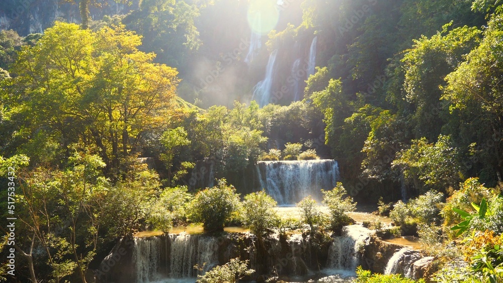 Beautiful waterfall in green tropical forest. Mountain jungle with ...