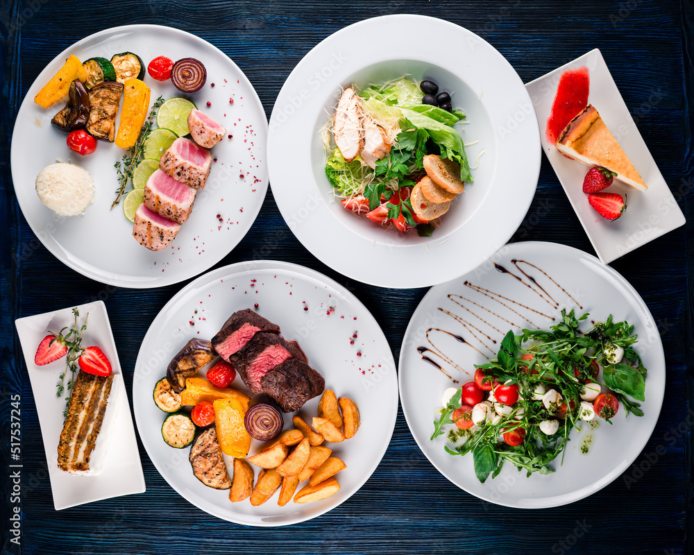 table set for two with a main course, salad and dessert Stock Photo ...