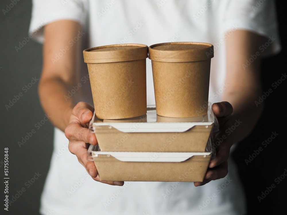 Stack of food delivery boxes in hands. Anonymous hands holding stack of ...