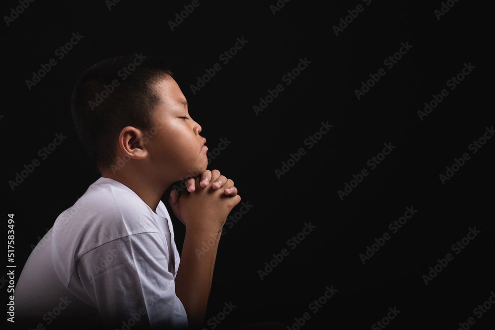 Boy praying to God at home Stock Photo | Adobe Stock