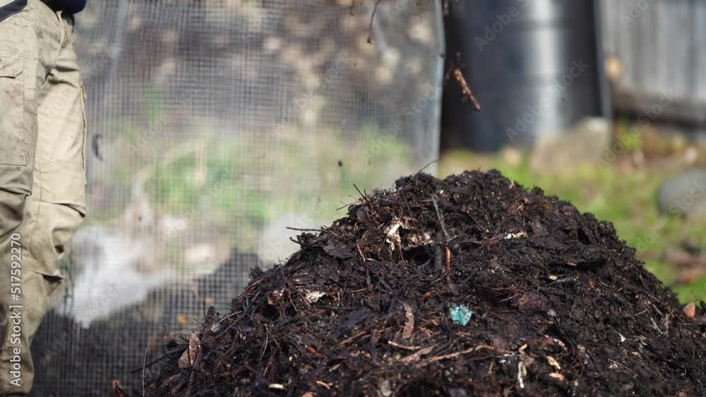 Farmer Turning compost pile, man mixing compost with pitchfork ...