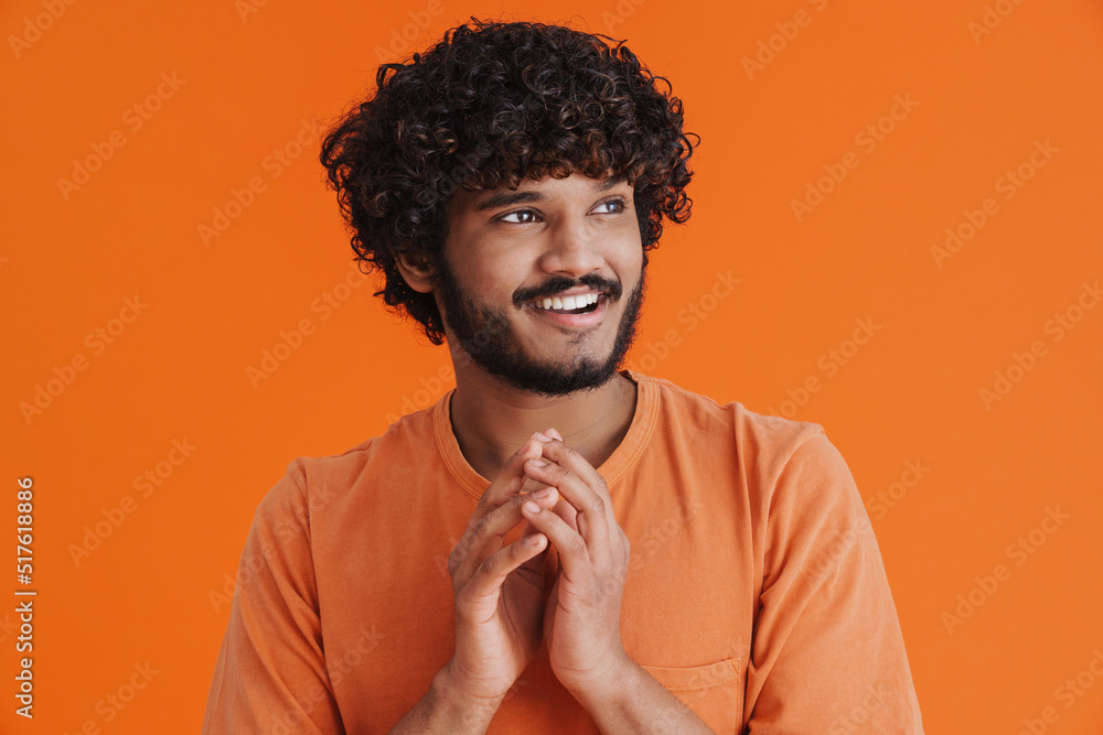 Yoiung indian insidious smiling handsome man rubbing his hands Stock ...
