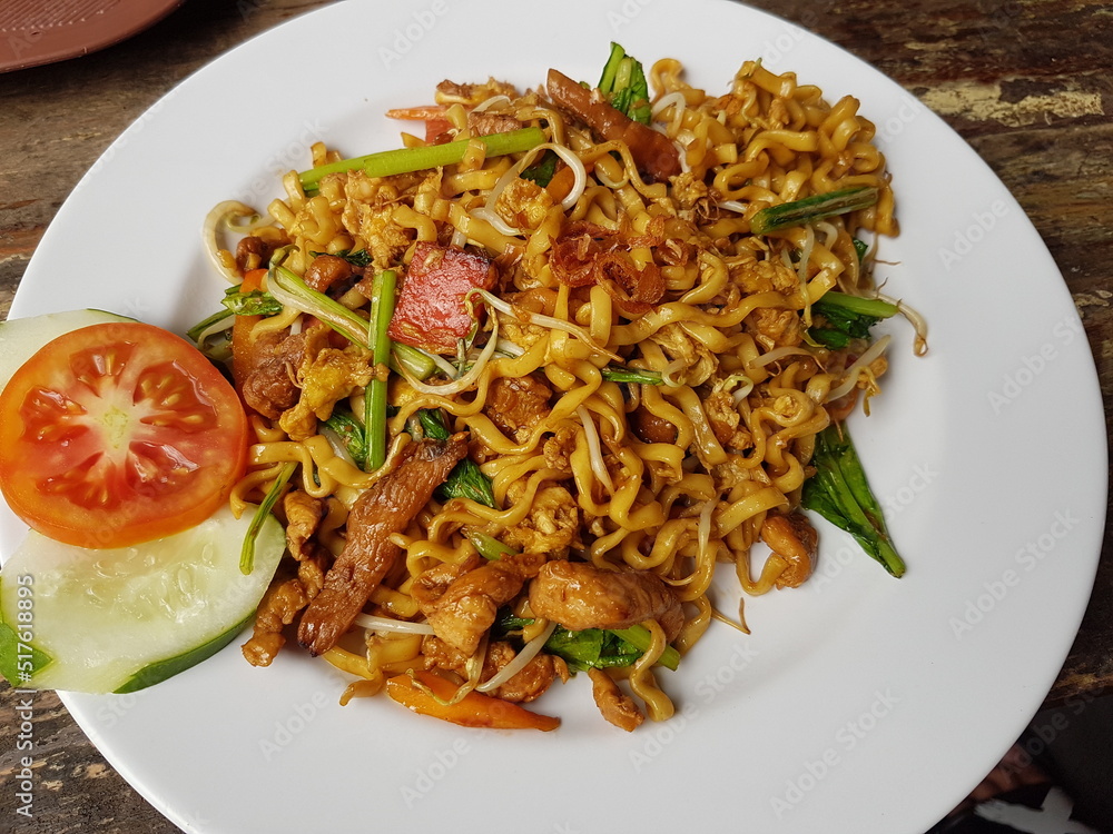 Kwetiau goreng is a Chinese Indonesian stir fried flat rice noodle dish ...