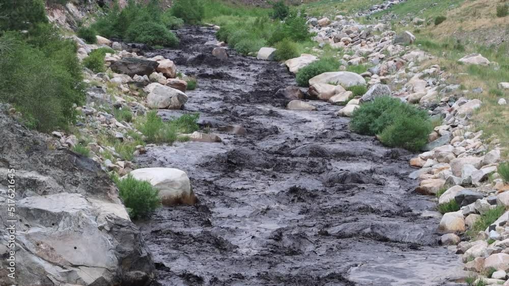Big Thompson river inundated with black soot and mud from a burn scar ...