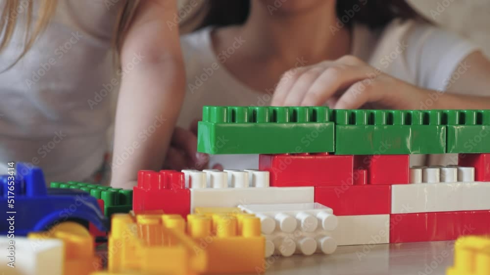little child plays constructor with his mother. happy family. kid ...