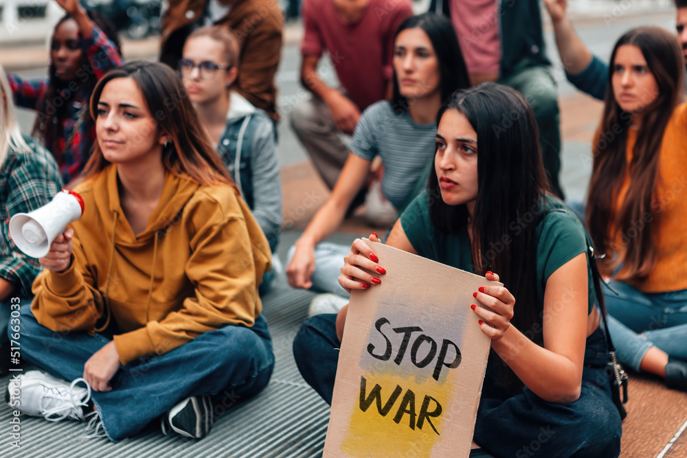 People Sitting On The Street Protesting For Peace - Cardboard With No ...