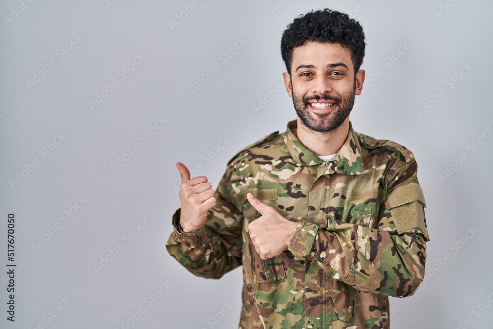 Arab man wearing camouflage army uniform pointing to the back behind ...