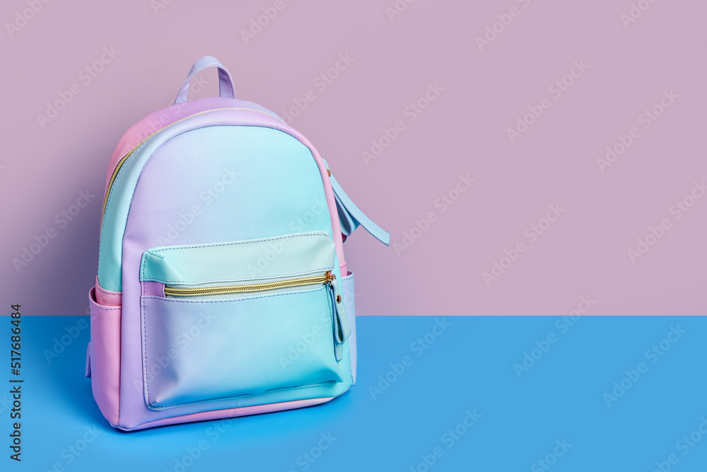 School backpack in pastel color on blue and pink background. Concept ...