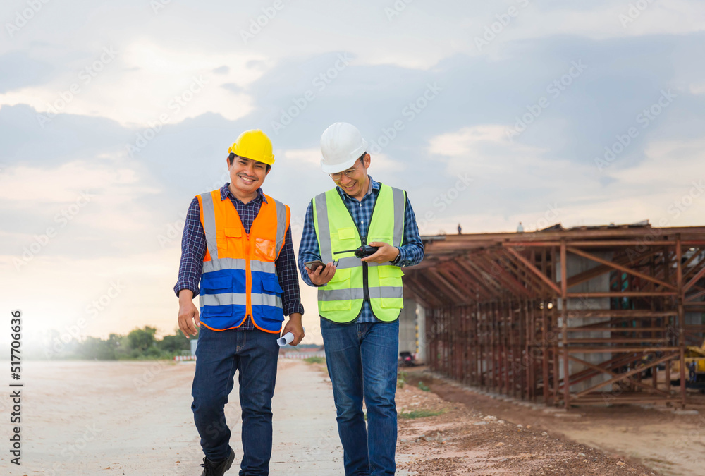 Engineer and foreman worker checking project at building site, Two ...