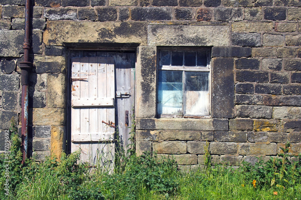 derelict abandoned old stone house with broken window and shabby wooden ...