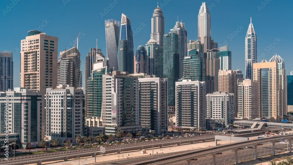 Dubai marina tallest block of skyscrapers timelapse with shadows moving ...