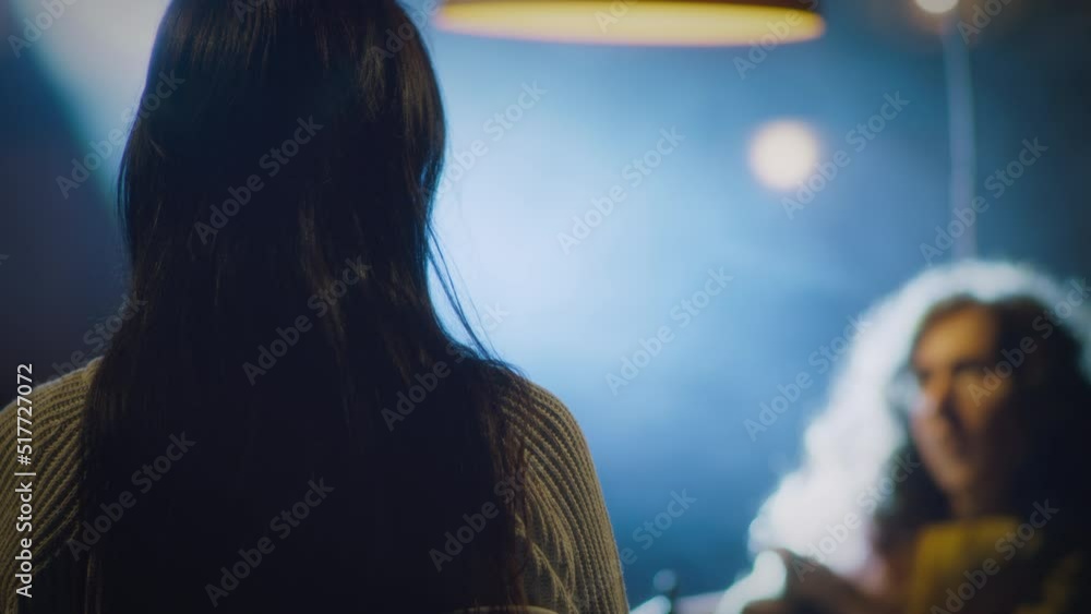 Rear view of an actress rehearsing a theatrical performance on dim ...