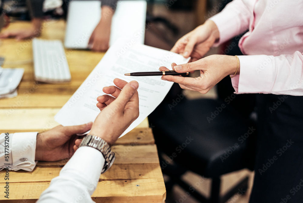 Unrecognizable man taking pen from coworker Stock Photo | Adobe Stock