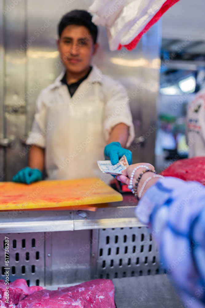 Butcher receiving payment from customer Stock Photo | Adobe Stock