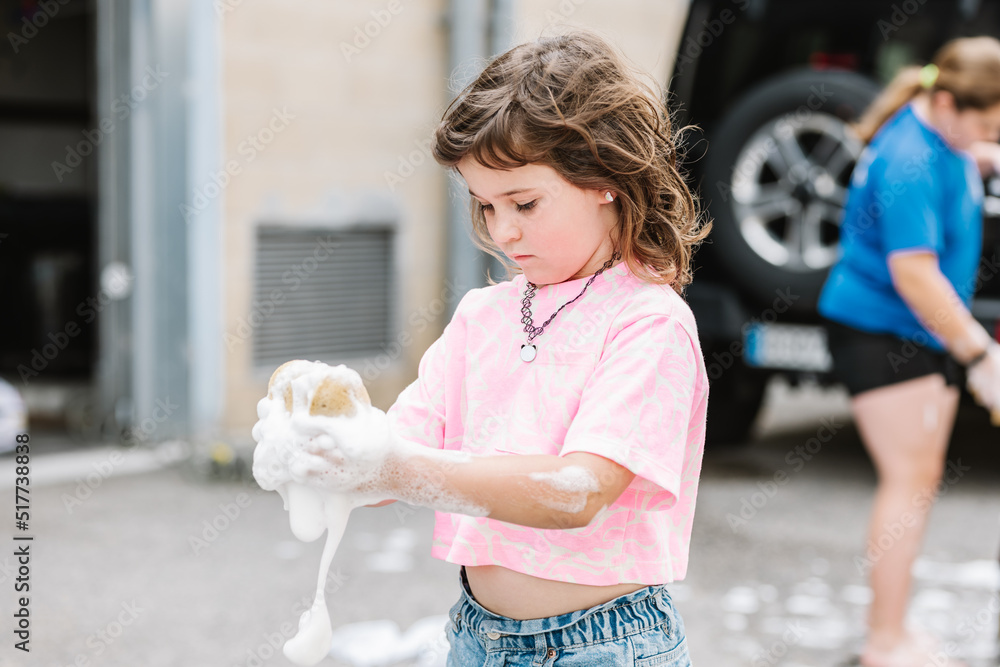 Cute Little Girl Squeezing Soap From Sponge Stock Photo | Adobe Stock